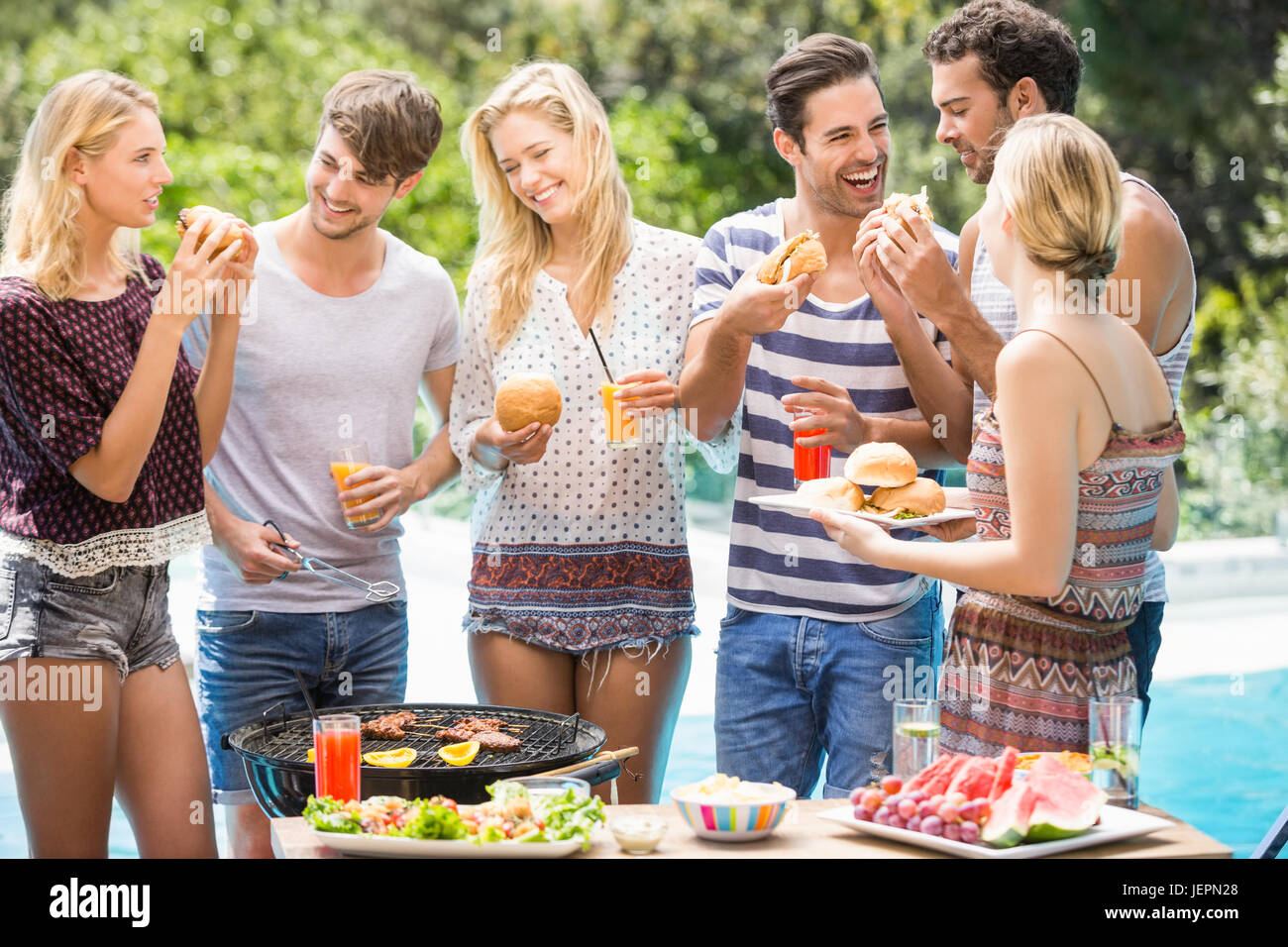 Group of friends having hamburgers and juice Stock Photo - Alamy