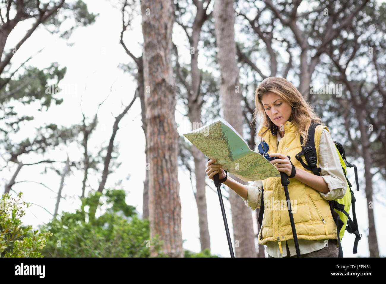 Woman with map and compass Stock Photo - Alamy