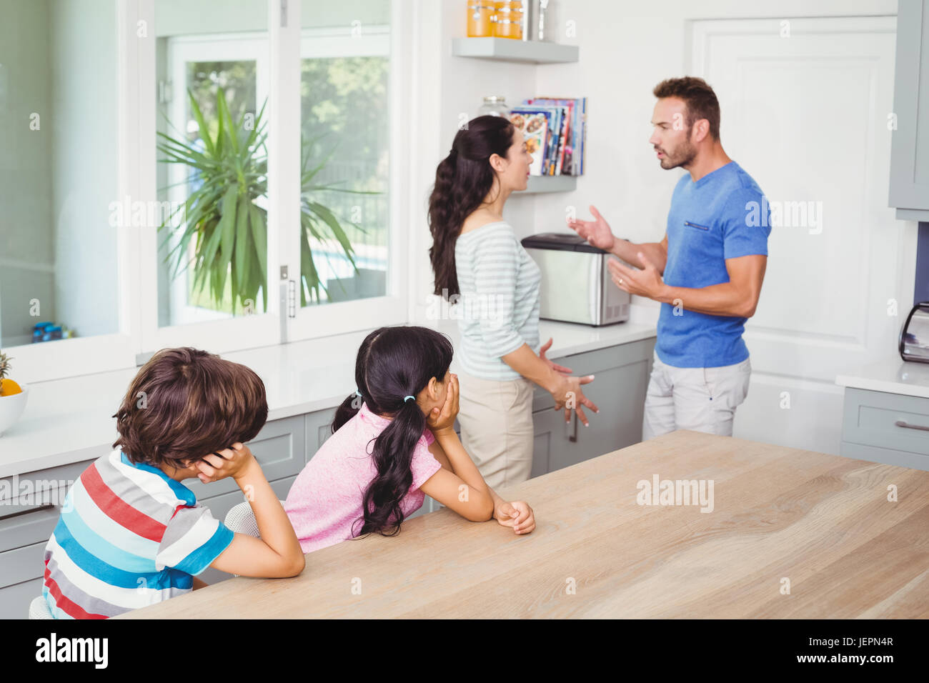 Children looking at parents Stock Photo - Alamy