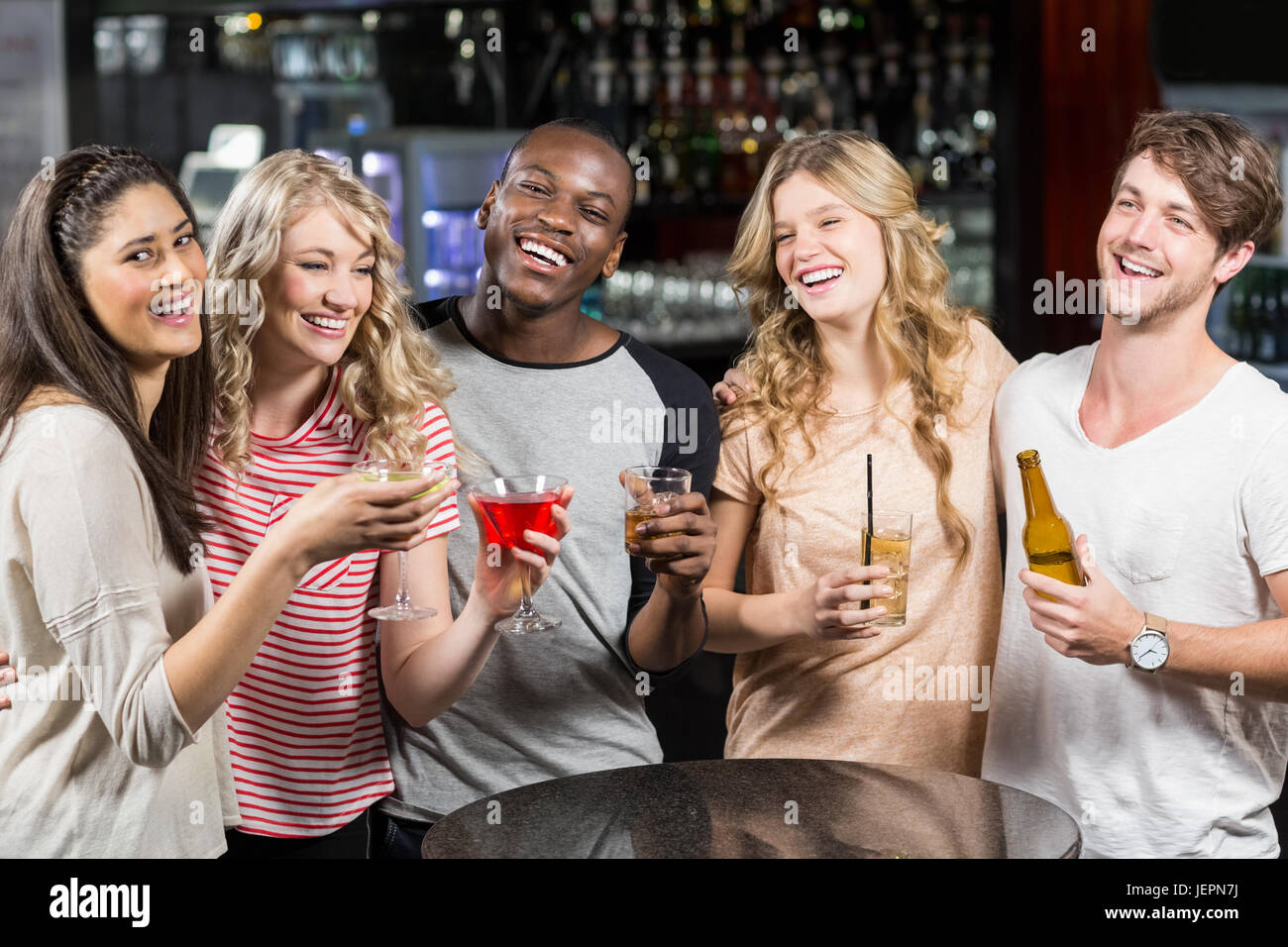 Group of friends having a drink Stock Photo - Alamy