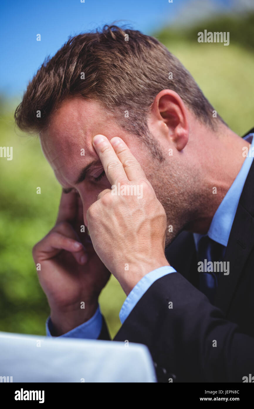 Nervous businessman having a headache Stock Photo - Alamy