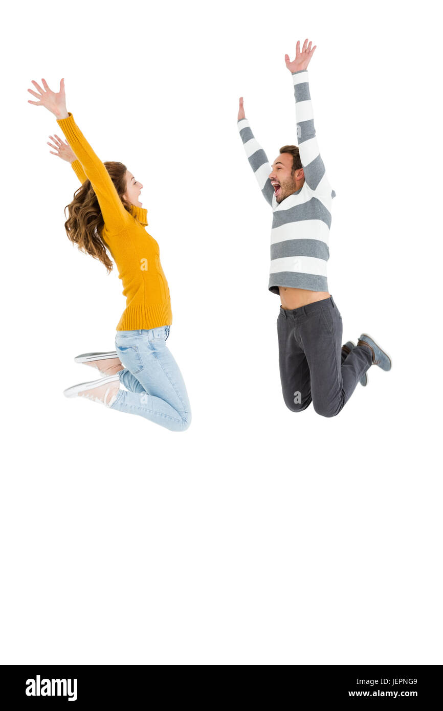 Happy couple jumping in excited Stock Photo - Alamy
