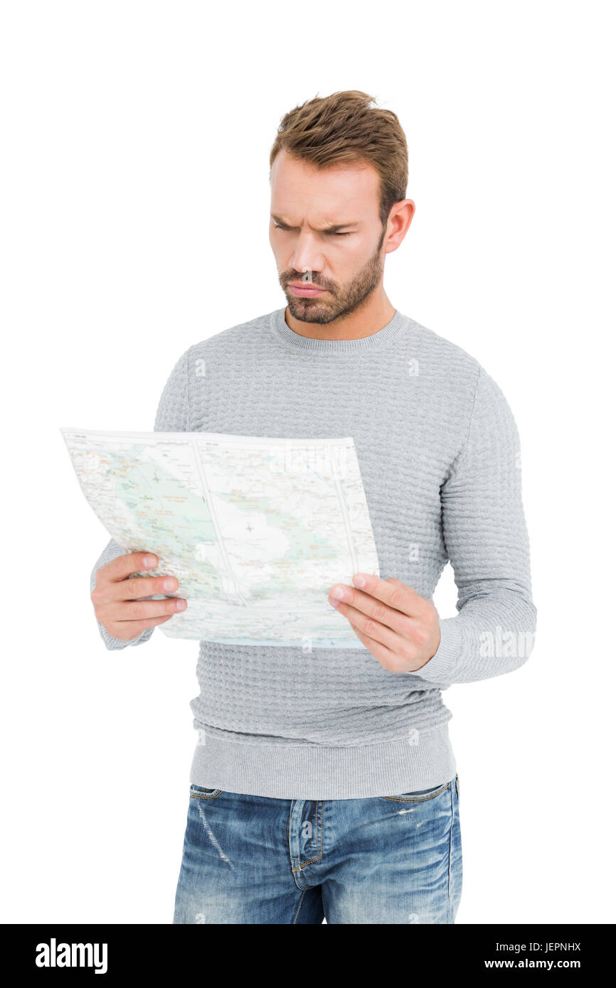 Young man looking at map Stock Photo - Alamy