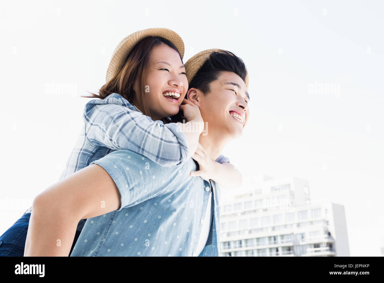 Young man giving a piggyback ride to woman Stock Photo - Alamy