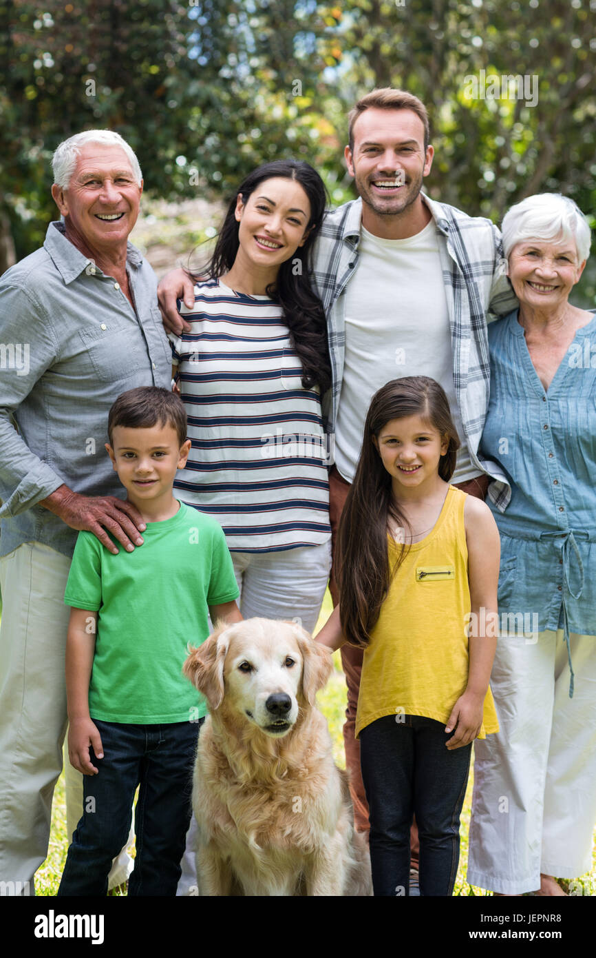 Happy family standing in a park Stock Photo - Alamy