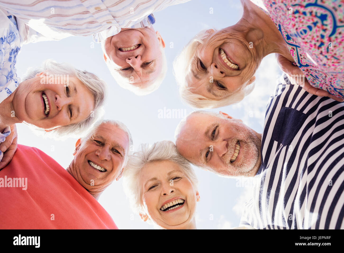 Senior friends standing in circle Stock Photo - Alamy