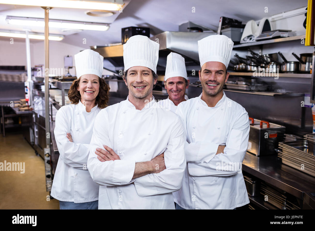 Group of happy chefs smiling at the camera Stock Photo - Alamy