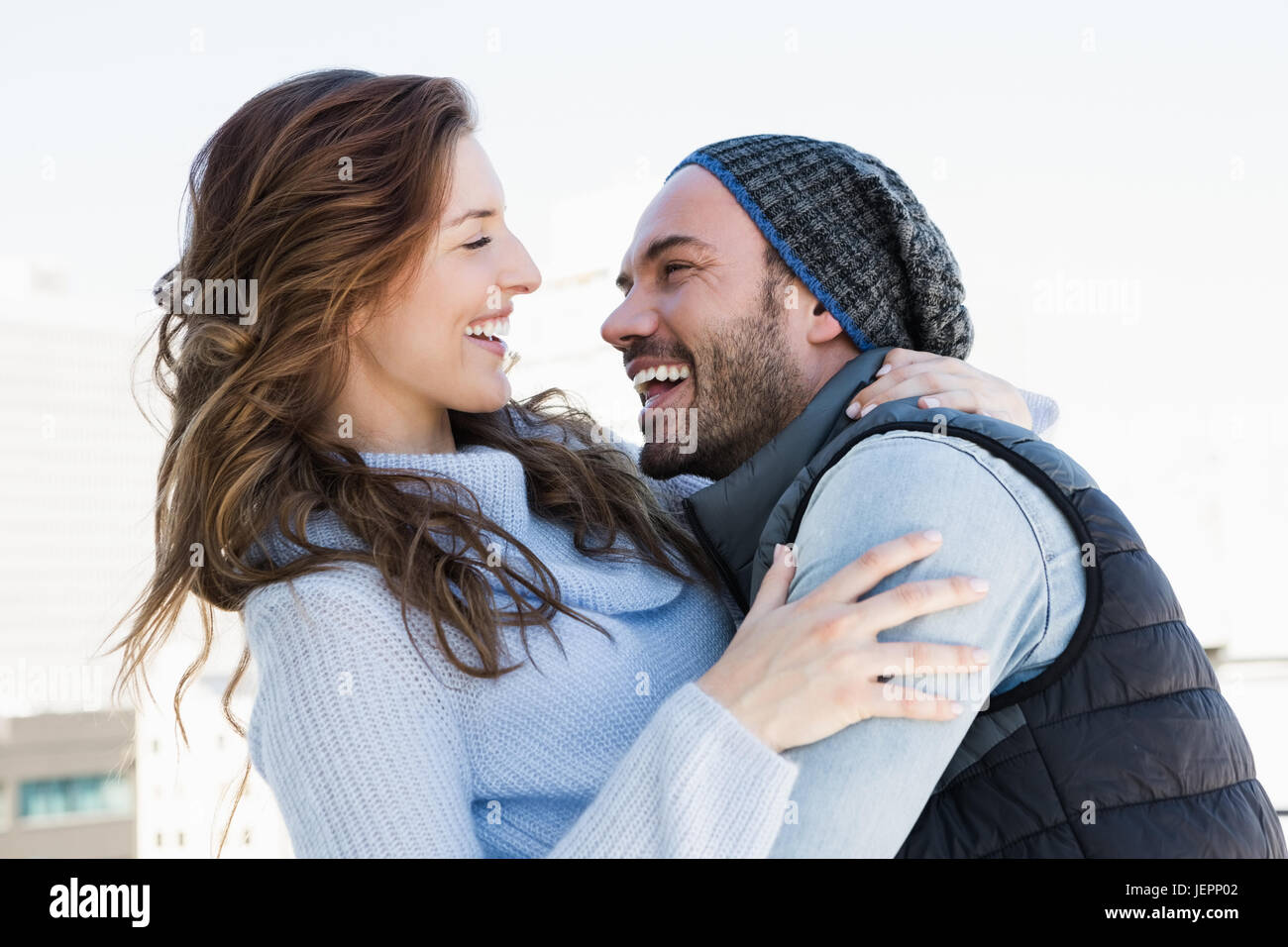 Happy couple cuddling each other Stock Photo - Alamy