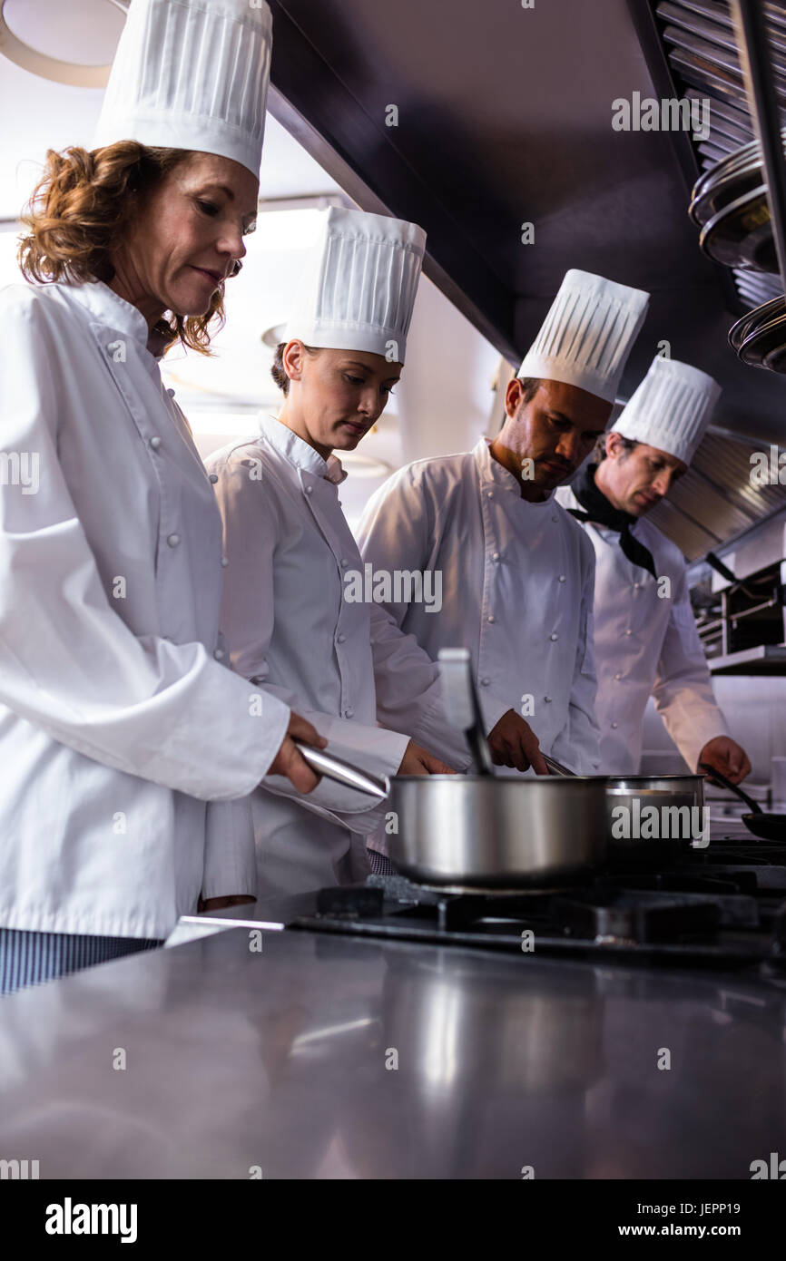 Chefs preparing food in kitchen Stock Photo - Alamy