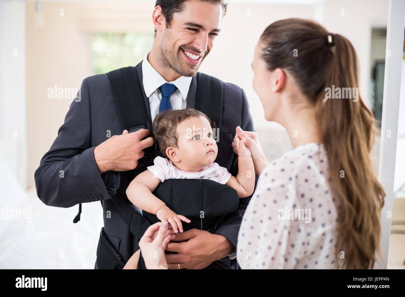 Happy father carrying baby with mother Stock Photo - Alamy