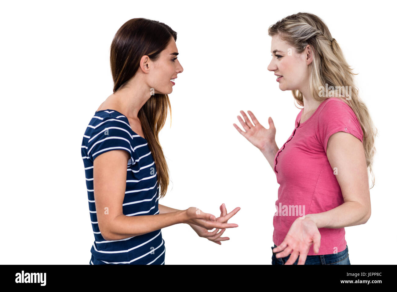 Female friends gesturing while arguing Stock Photo - Alamy