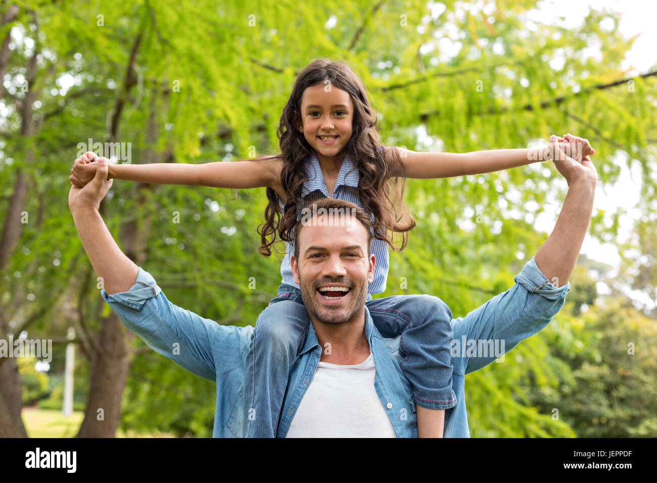 Father carrying her daughter on shoulder Stock Photo - Alamy