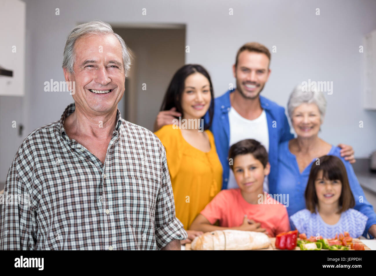 Elderly man standing in kitchen Stock Photo - Alamy