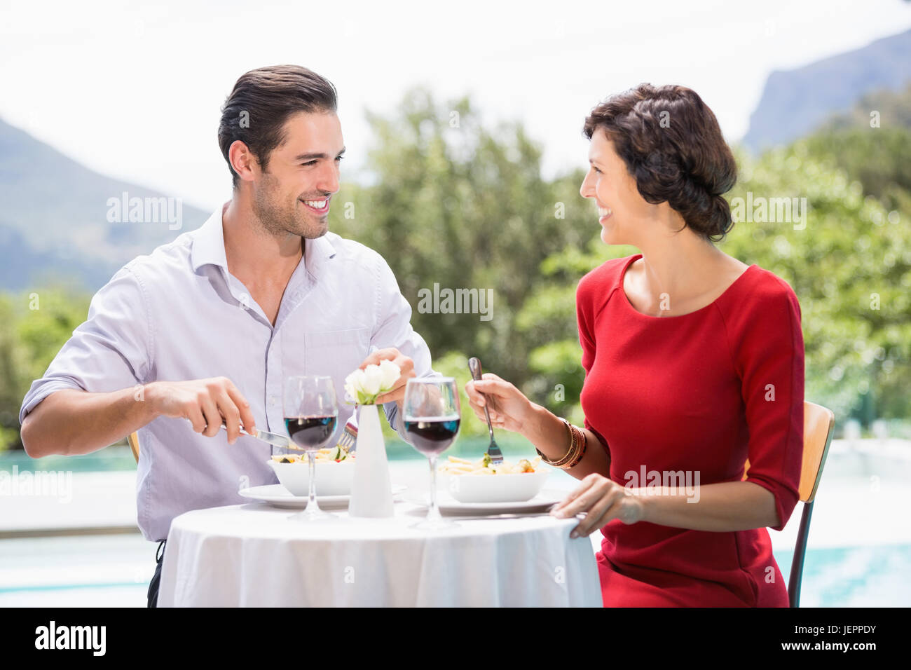 Happy couple having food Stock Photo - Alamy