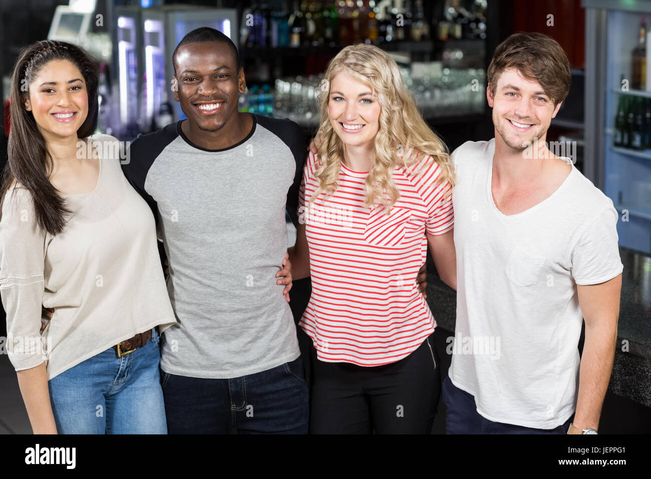 Happy friends smiling at camera Stock Photo - Alamy