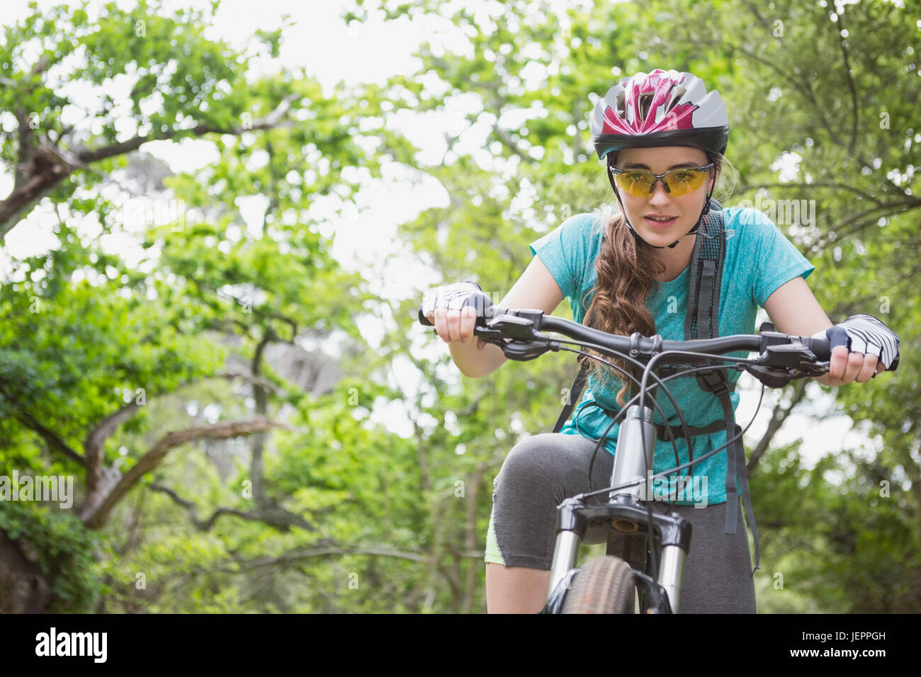 Woman riding her bike Stock Photo - Alamy