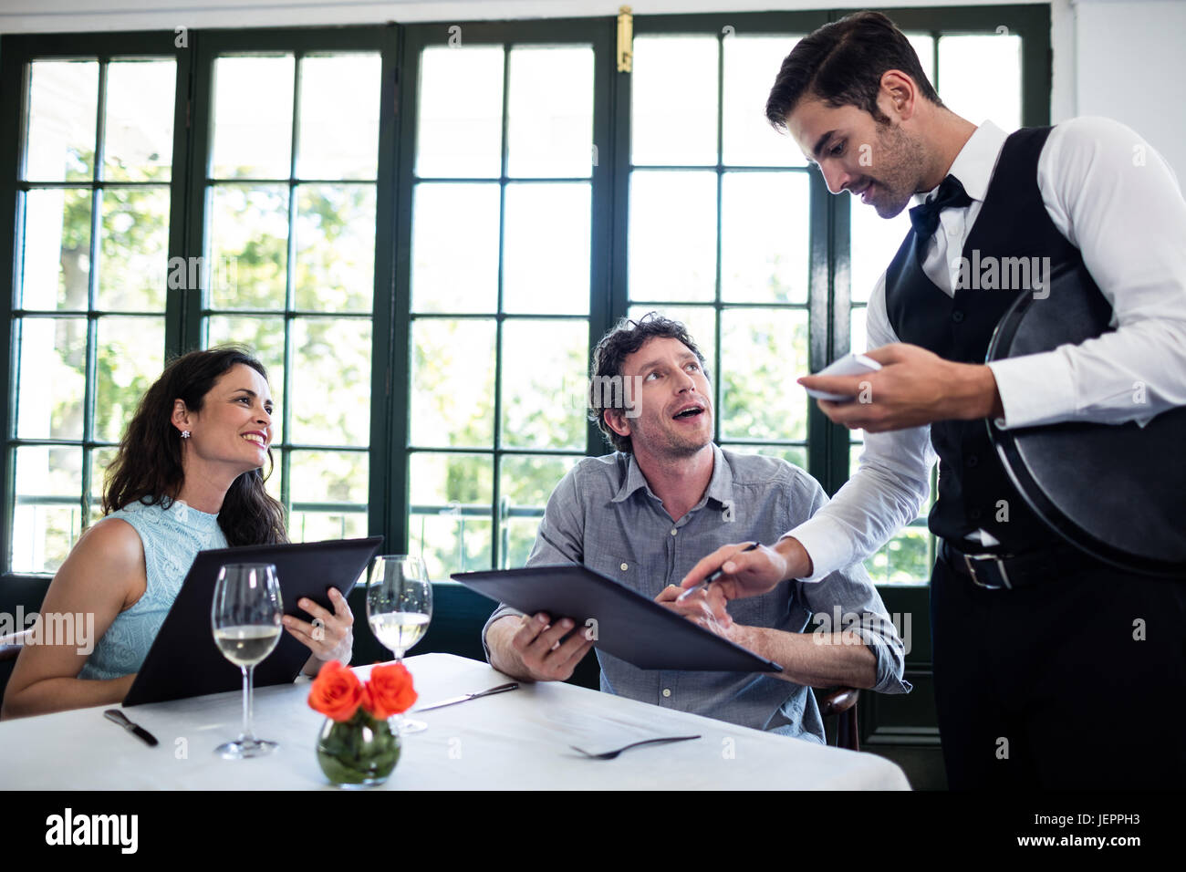 Handsome waiter taking an order hi-res stock photography and images - Alamy