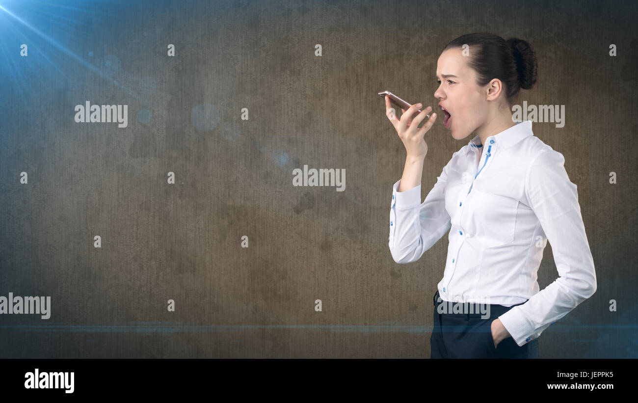 Angry businesswoman, standing by side and talking by mobile phone and ...