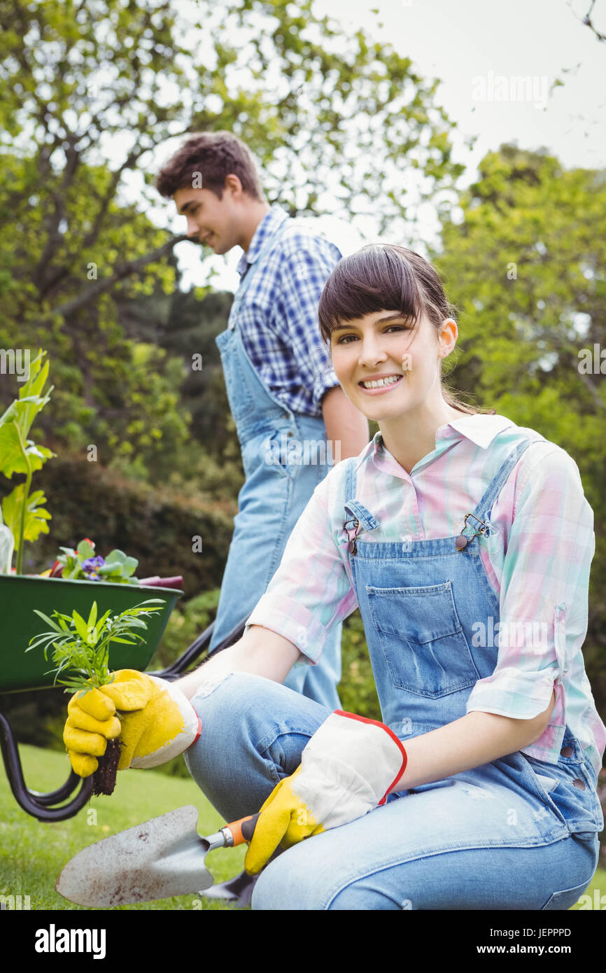 Young woman planting a sapling Stock Photo - Alamy