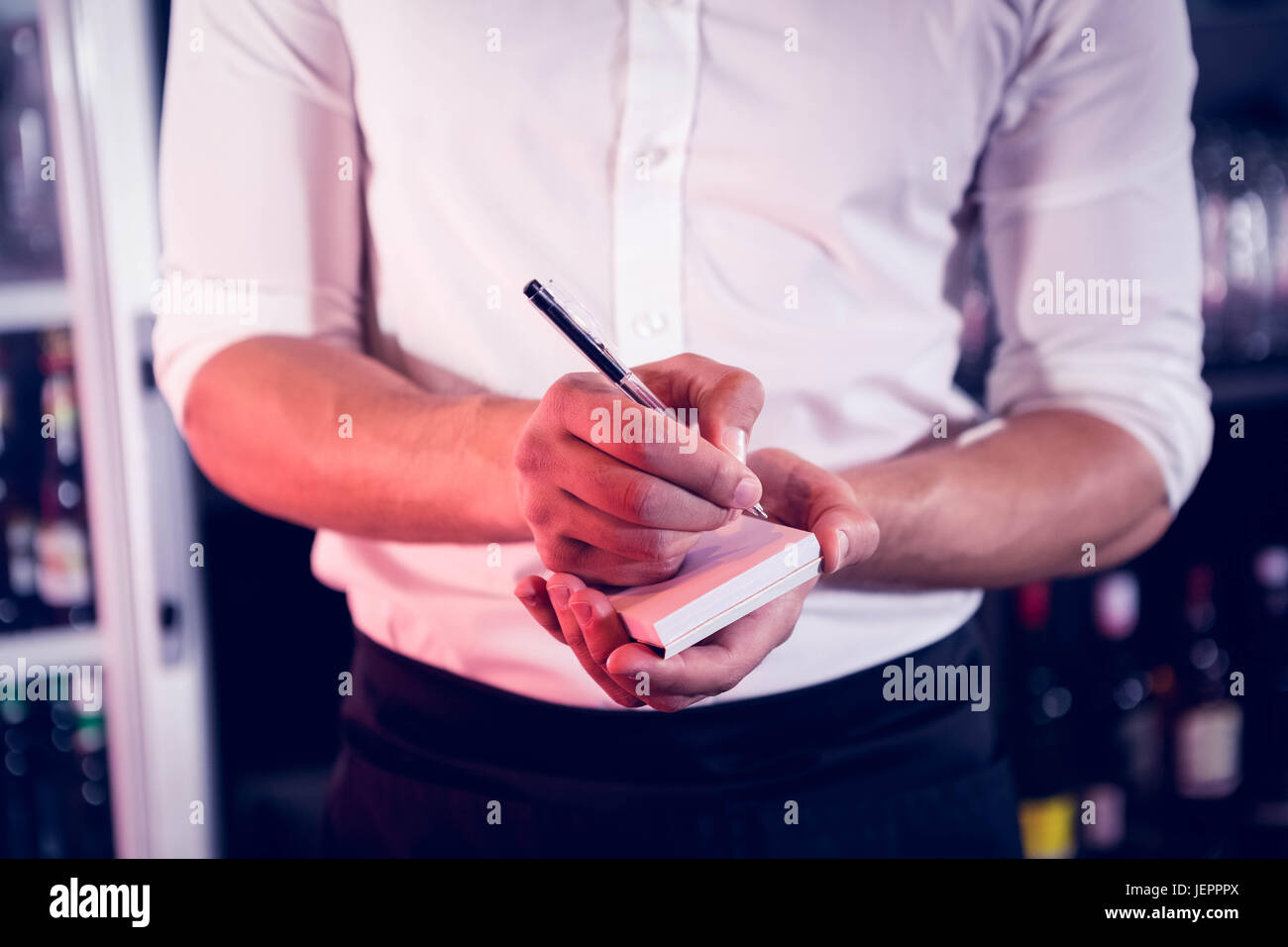 Waiter writing down an order Stock Photo - Alamy