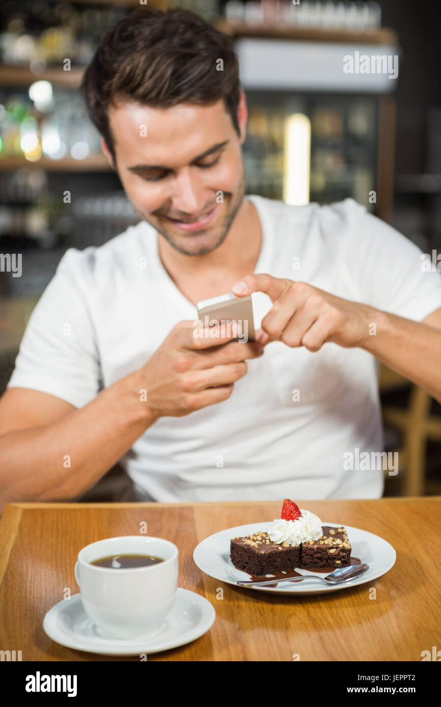 Handsome man taking a picture of his food Stock Photo - Alamy
