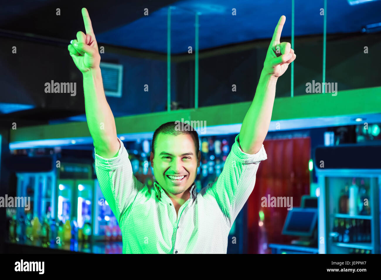 Happy man dancing in front of bar counter Stock Photo - Alamy