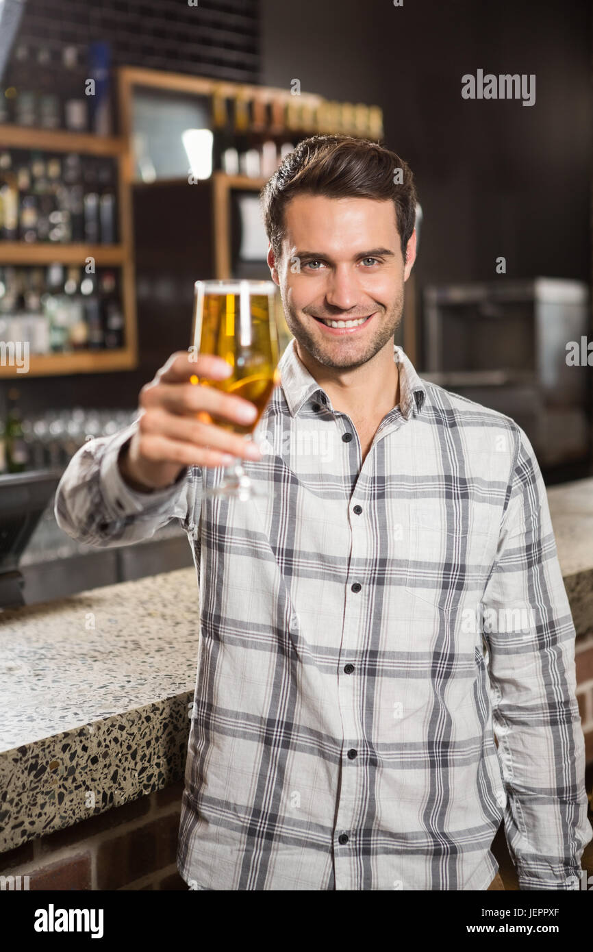 Handsome man toasting with a pint Stock Photo - Alamy