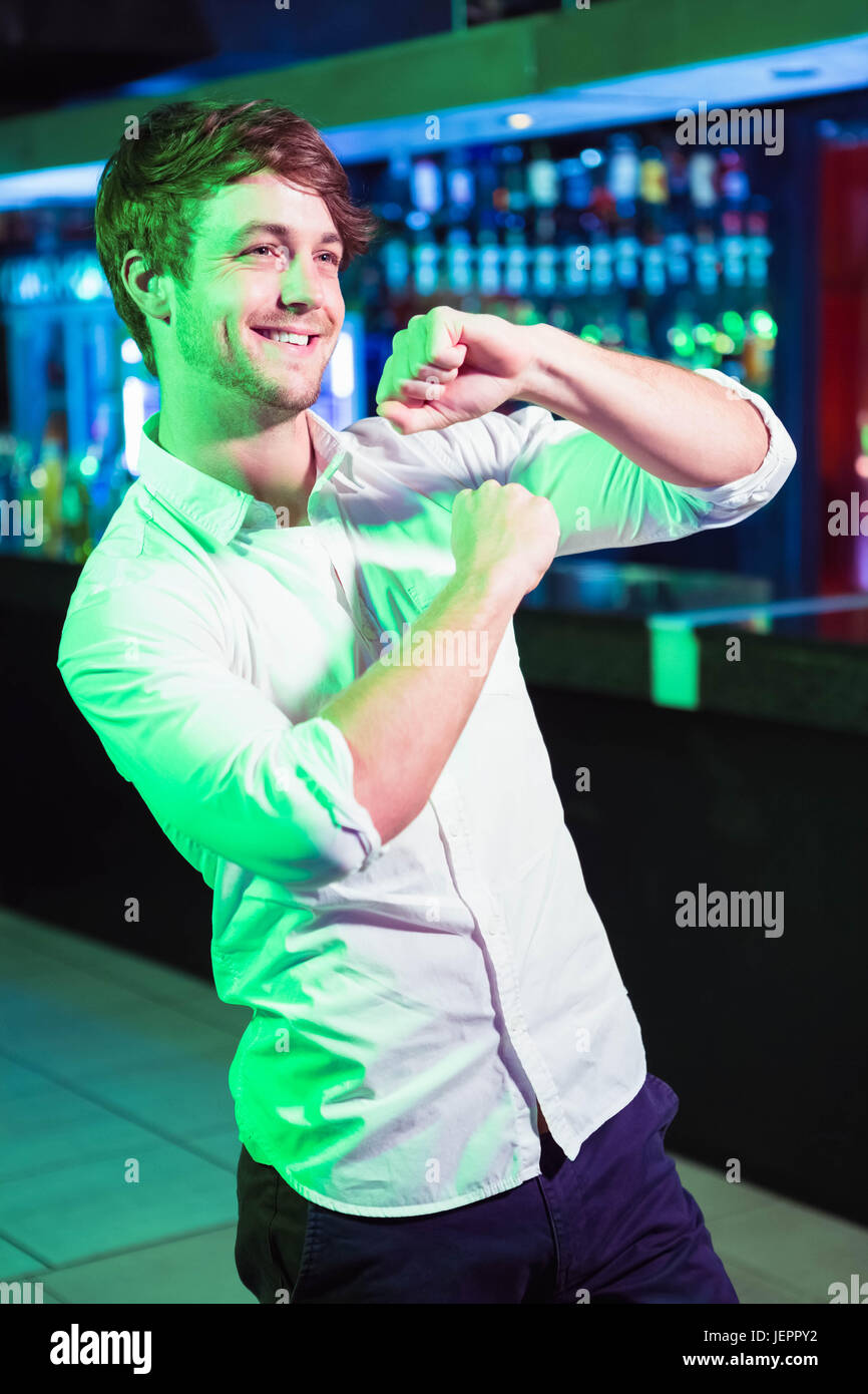 Happy man dancing in front of bar counter Stock Photo - Alamy