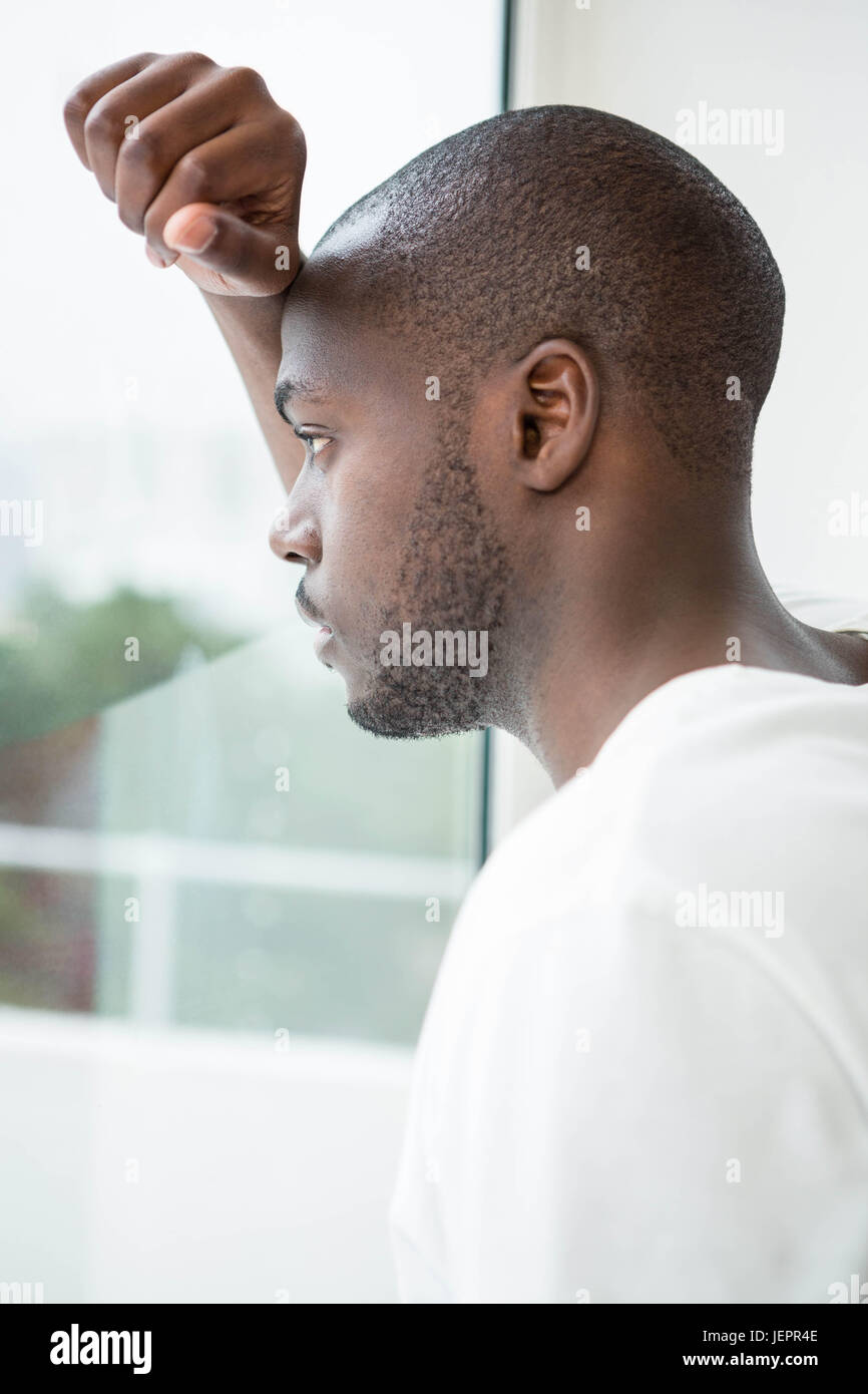 Thoughtful man looking out of window Stock Photo - Alamy