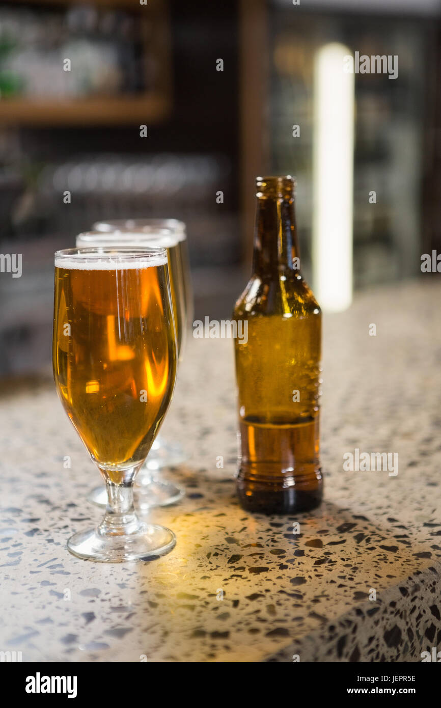 View of pints of beer and bottle Stock Photo - Alamy