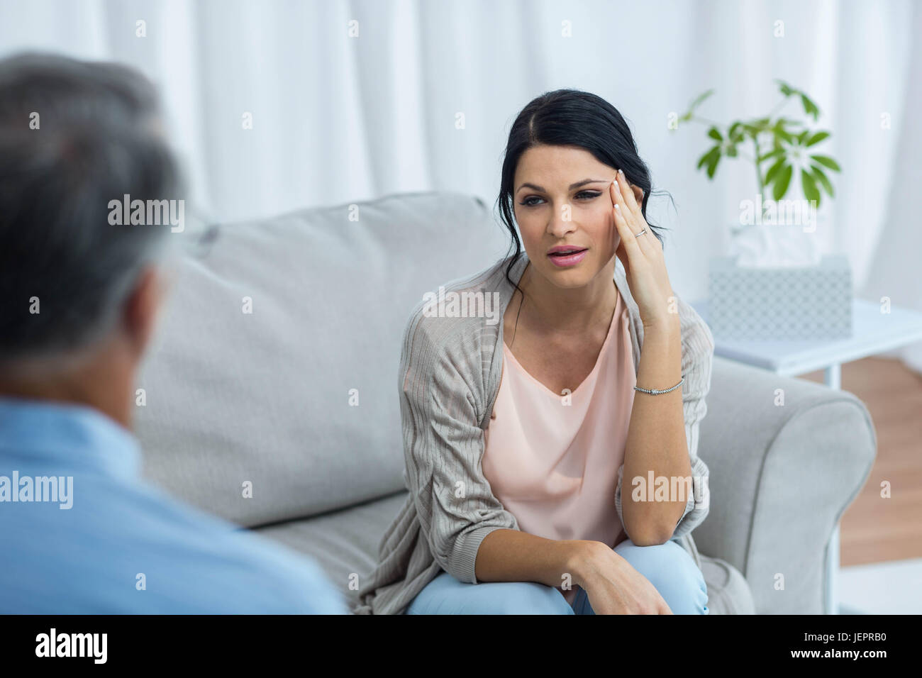 Worried woman sitting therapist hi-res stock photography and images - Alamy