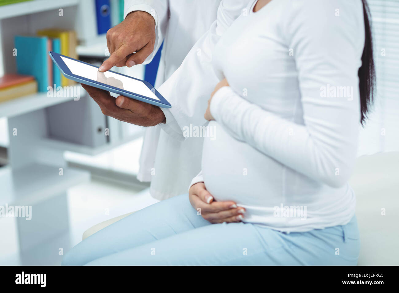 Female healthcare professional interacting tablet hi-res stock photography and images - Alamy