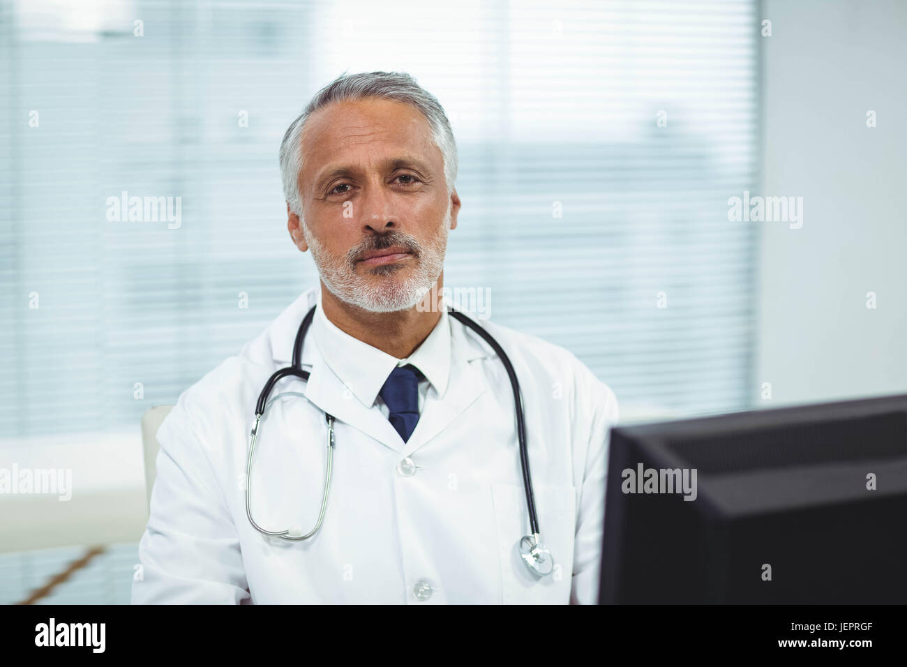 Doctor working on his computer Stock Photo - Alamy