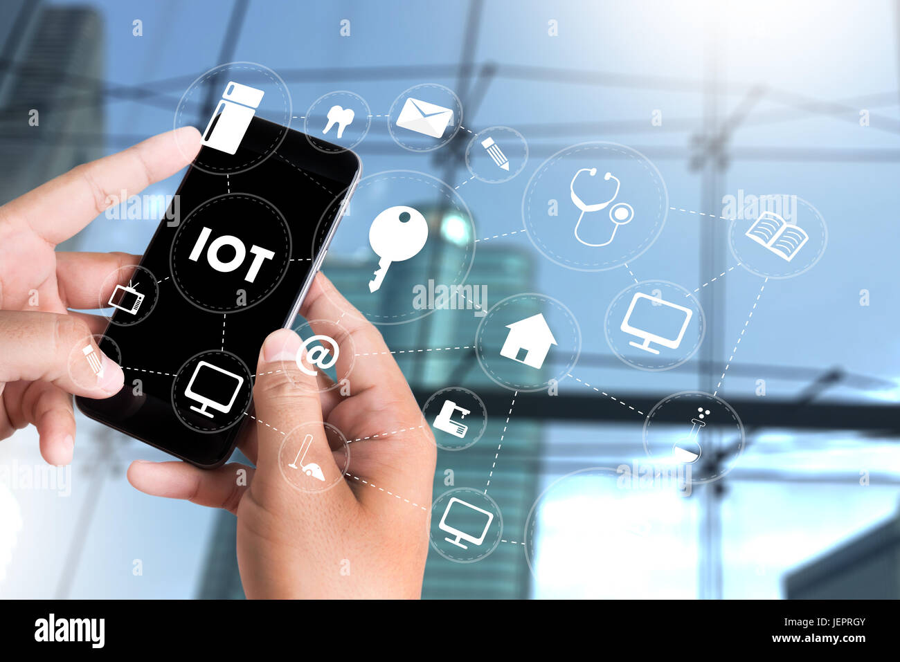 IOT business man hand working and internet of things (IoT) word diagram ...