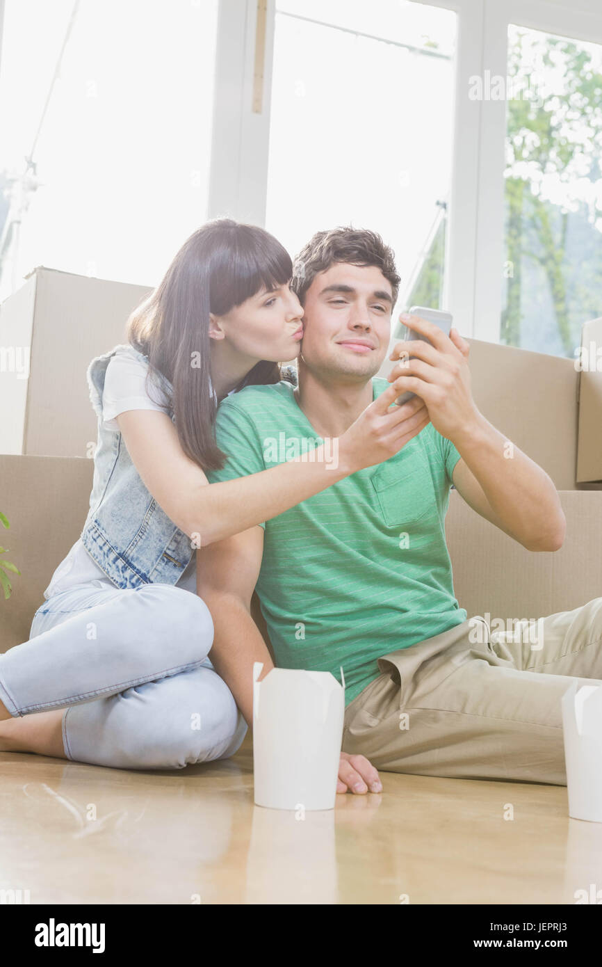 Young couple using mobile phone Stock Photo - Alamy