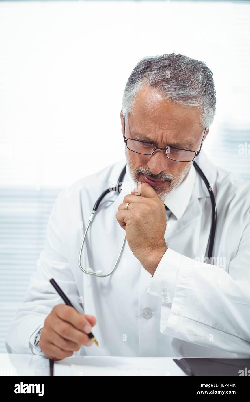 Doctor writing on notepad Stock Photo - Alamy