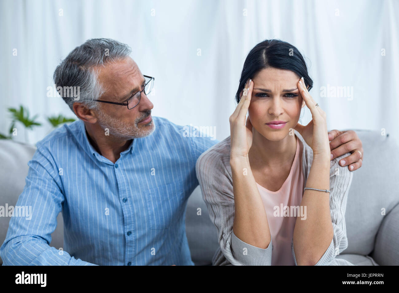 Therapist consoling a woman Stock Photo - Alamy