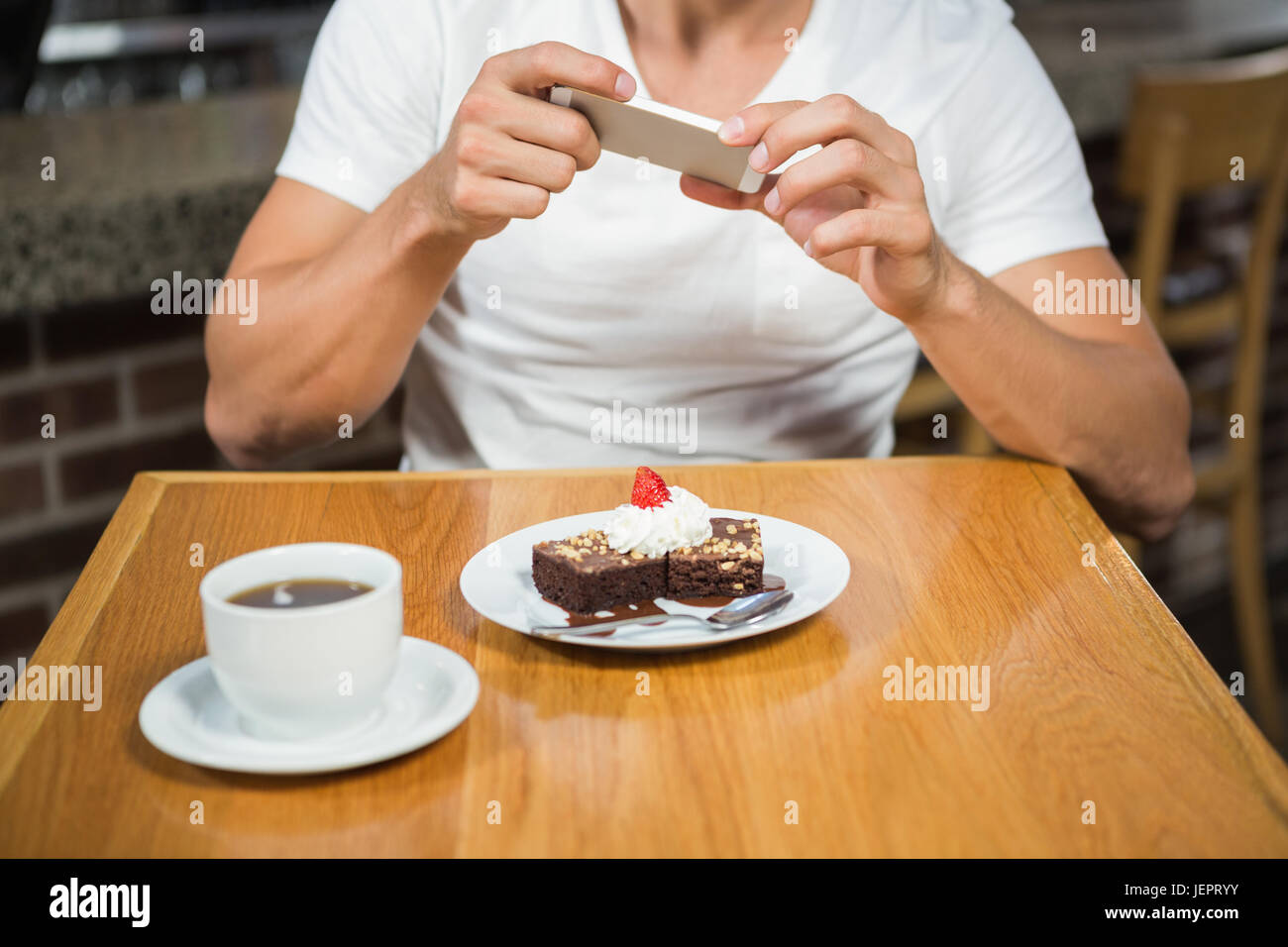 Handsome man taking a picture of his food Stock Photo - Alamy