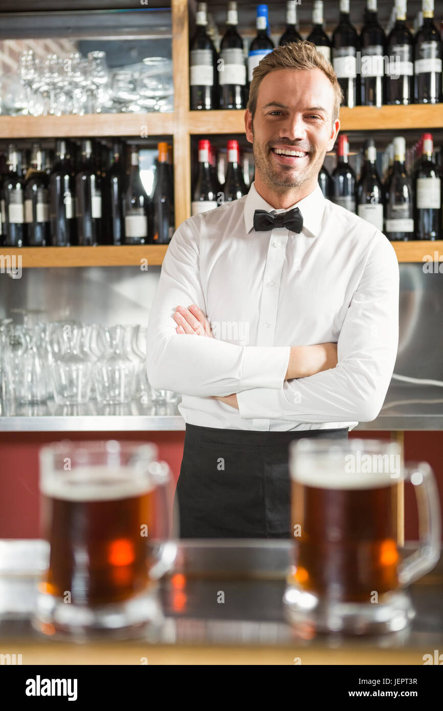 Handsome bar tender crossing his arms Stock Photo - Alamy