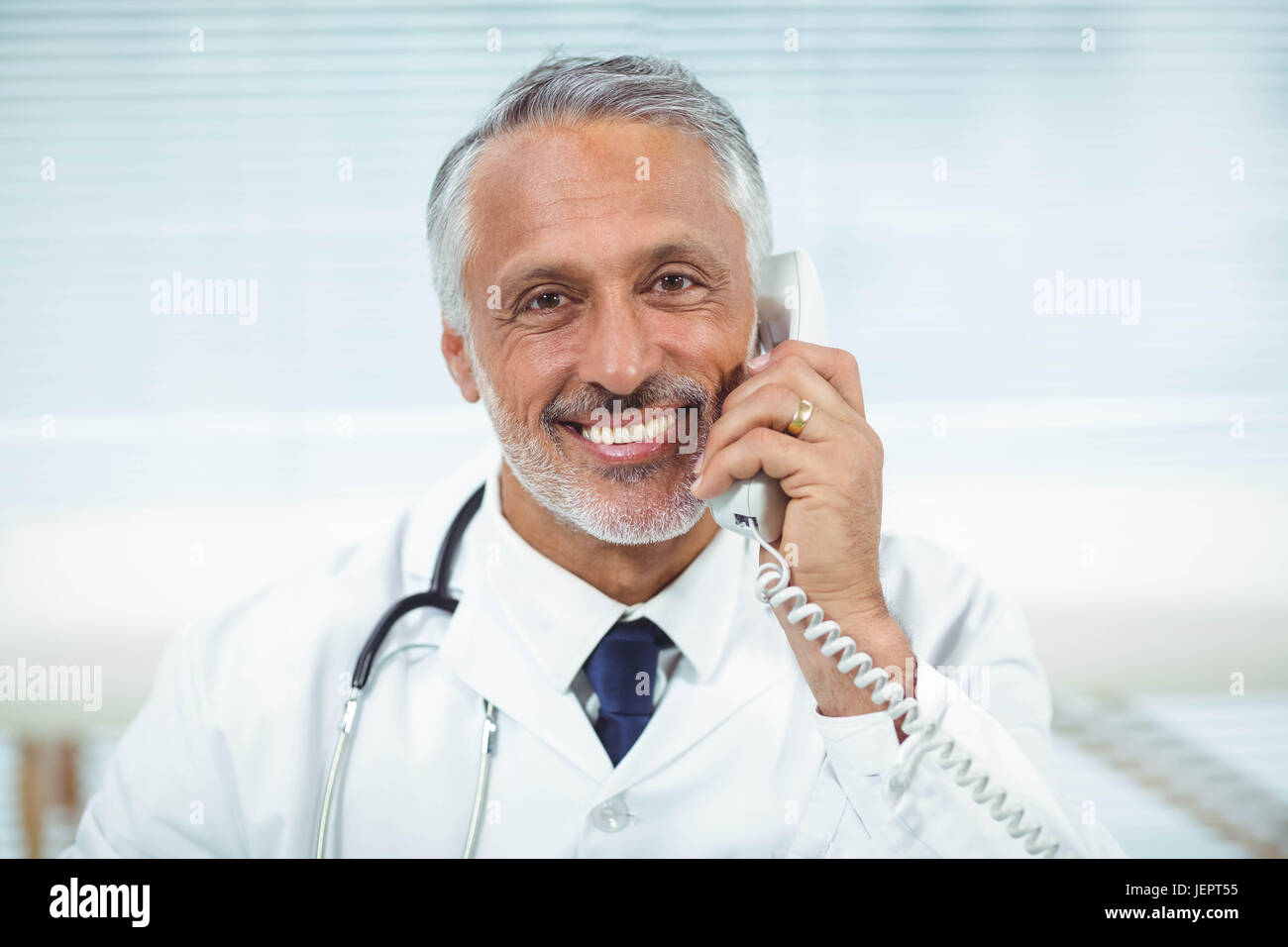 Doctor talking on phone Stock Photo - Alamy