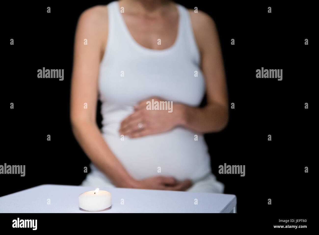 Pregnant woman and glass on table Stock Photo - Alamy