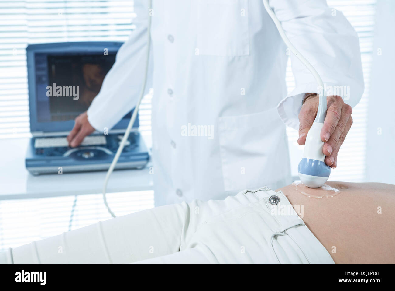 Pregnant woman undergoing ultrasound test Stock Photo - Alamy