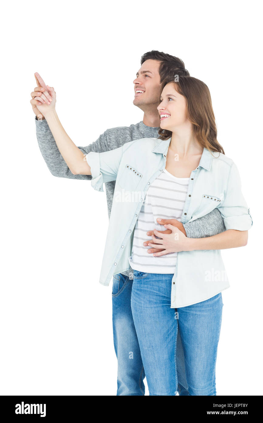Couple embracing and pointing up Stock Photo - Alamy