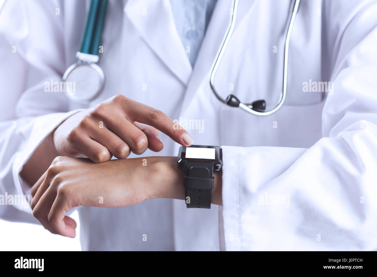 Asian doctor using her smart watch Stock Photo - Alamy