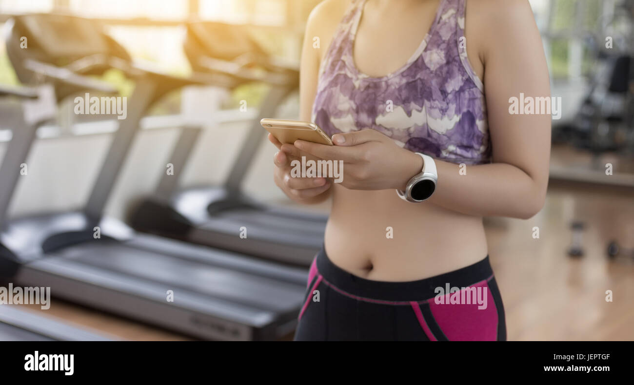 woman use phone fitness exercise in gym smart gadgets and sport ...