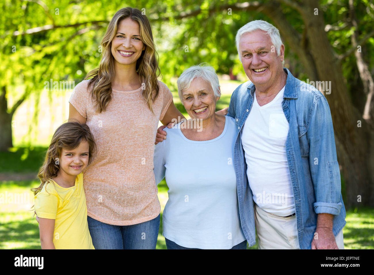 Smiling family standing Stock Photo - Alamy
