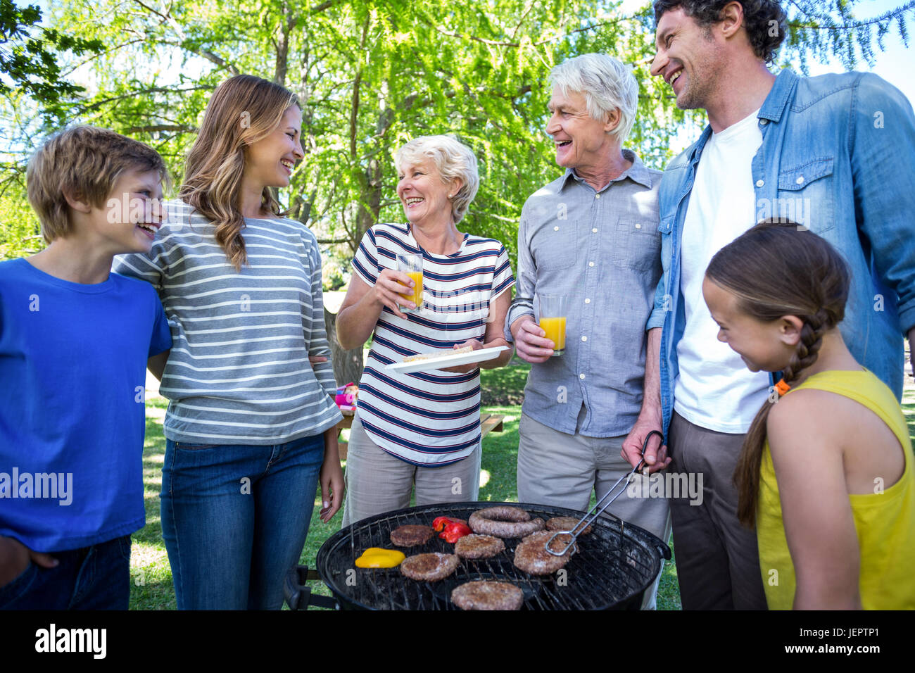 Family having a barbecue Stock Photo - Alamy