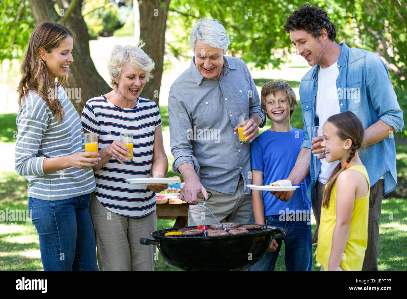 Family having a barbecue Stock Photo - Alamy