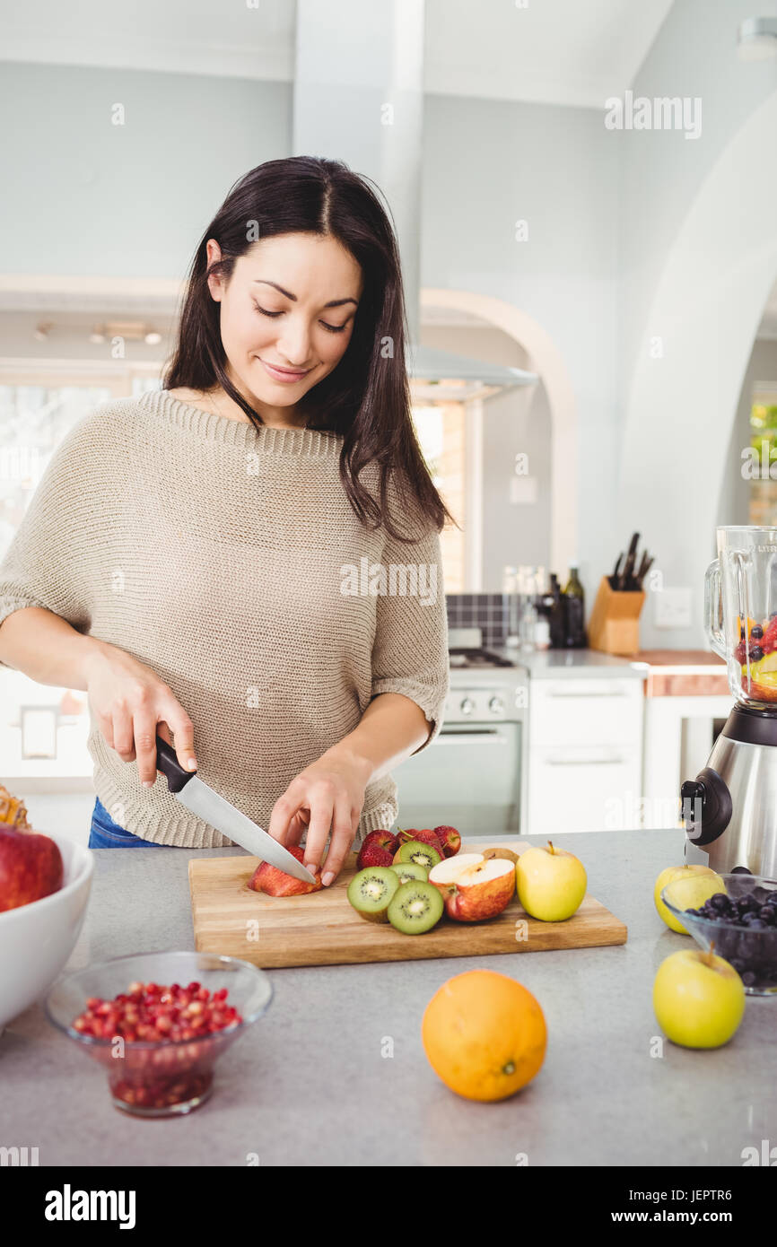 Woman cutting apple standing hi-res stock photography and images - Alamy