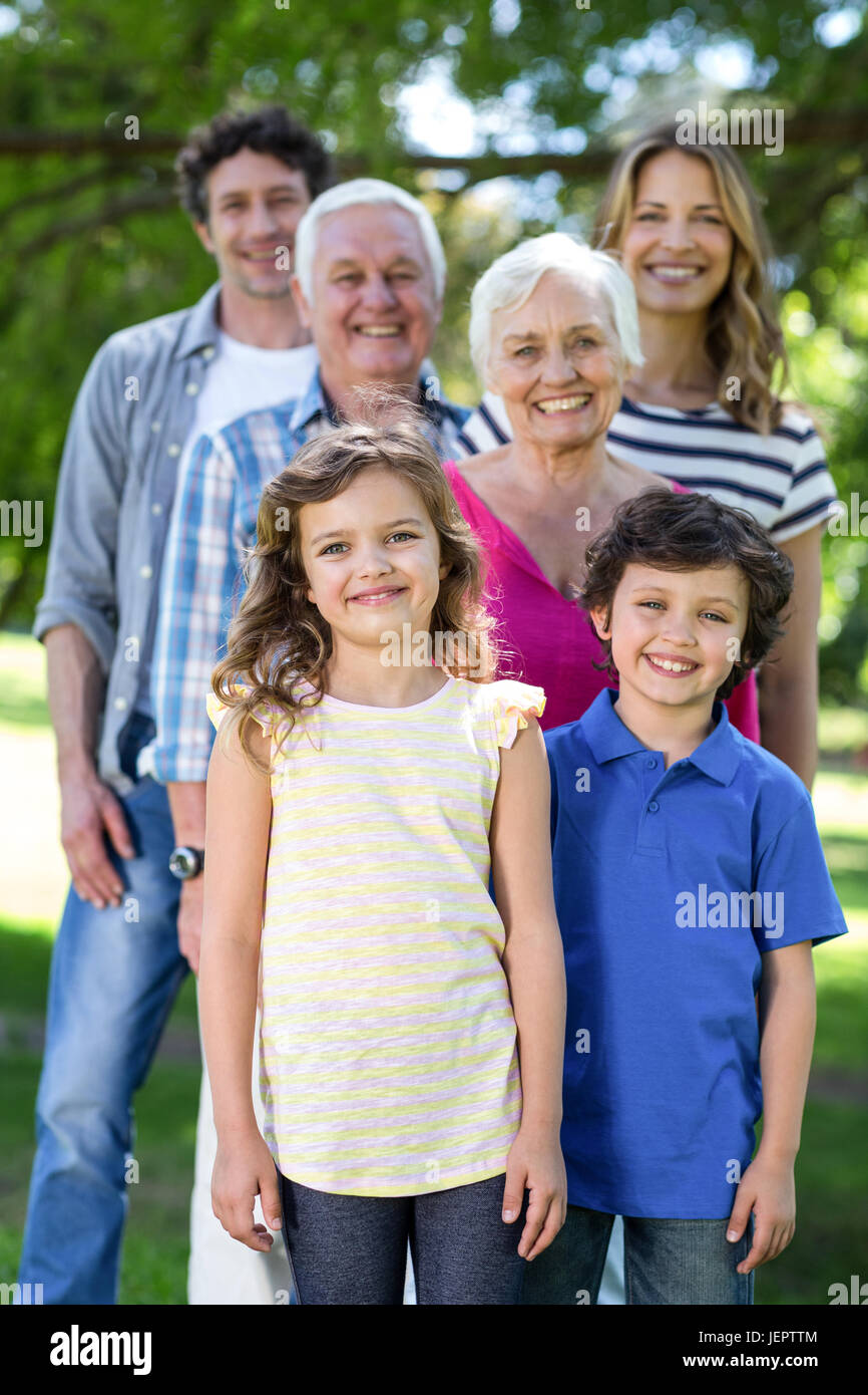 Smiling family standing in a row Stock Photo - Alamy